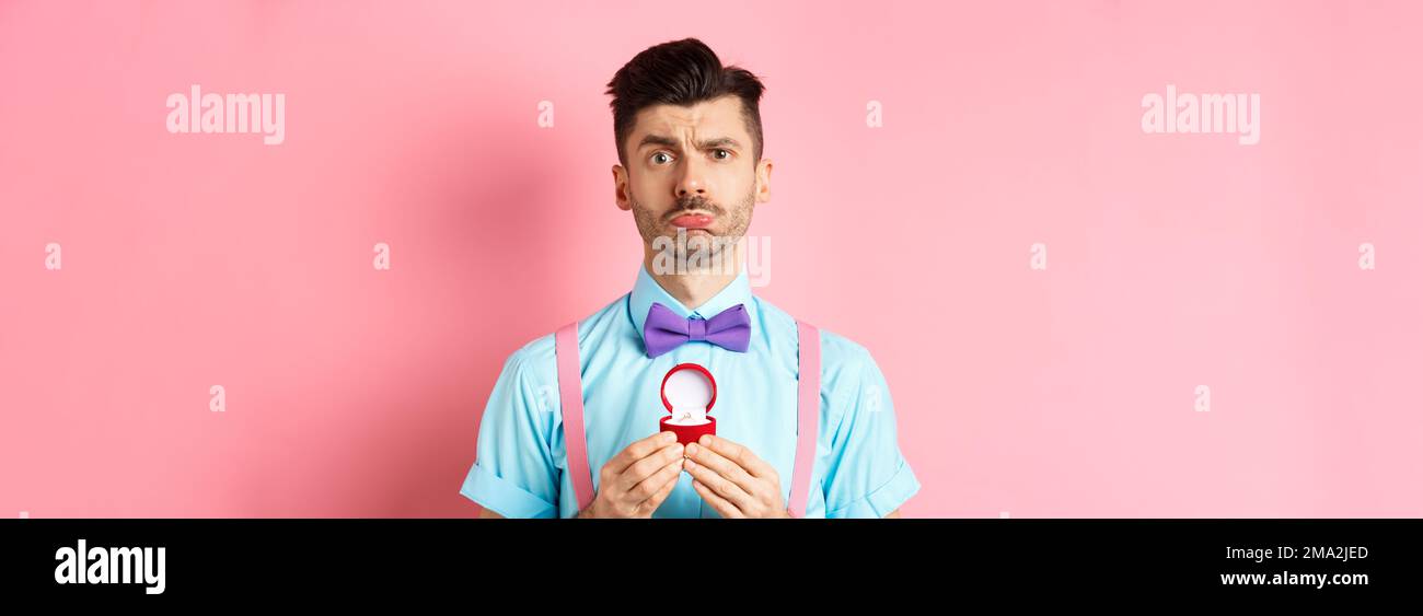 Valentines day. Sad boyfriend being rejected, showing engagement ring ...