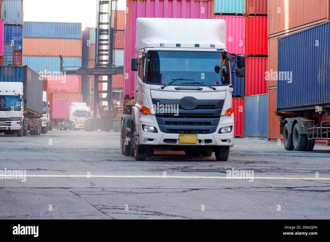 Trucks in the container yard Stock Photo - Alamy