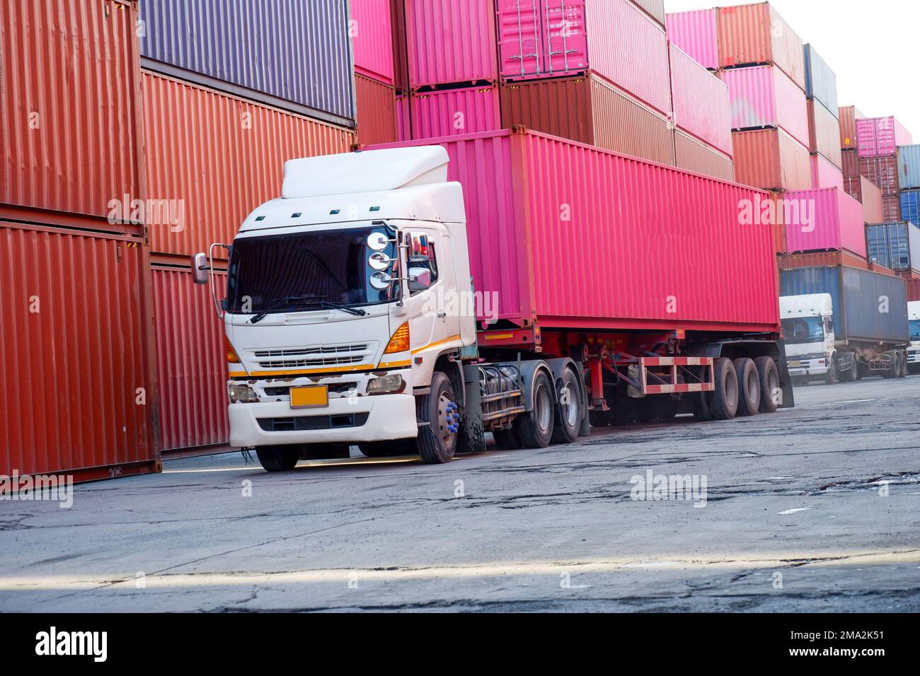 Trucks in the container yard Stock Photo - Alamy