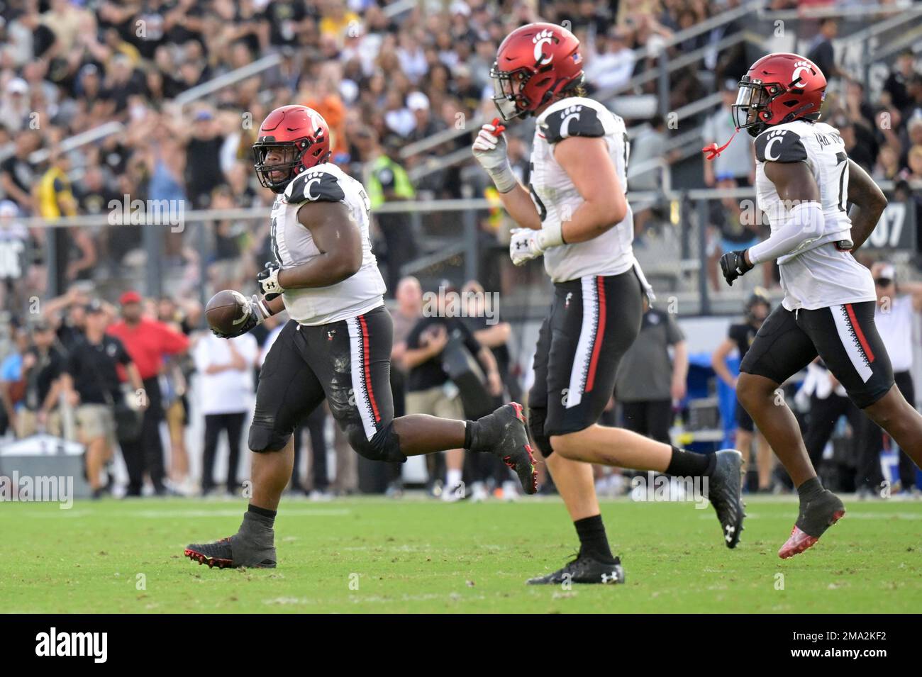 Cincinnati defensive lineman Dontay Corleone (58), left, reacts after ...