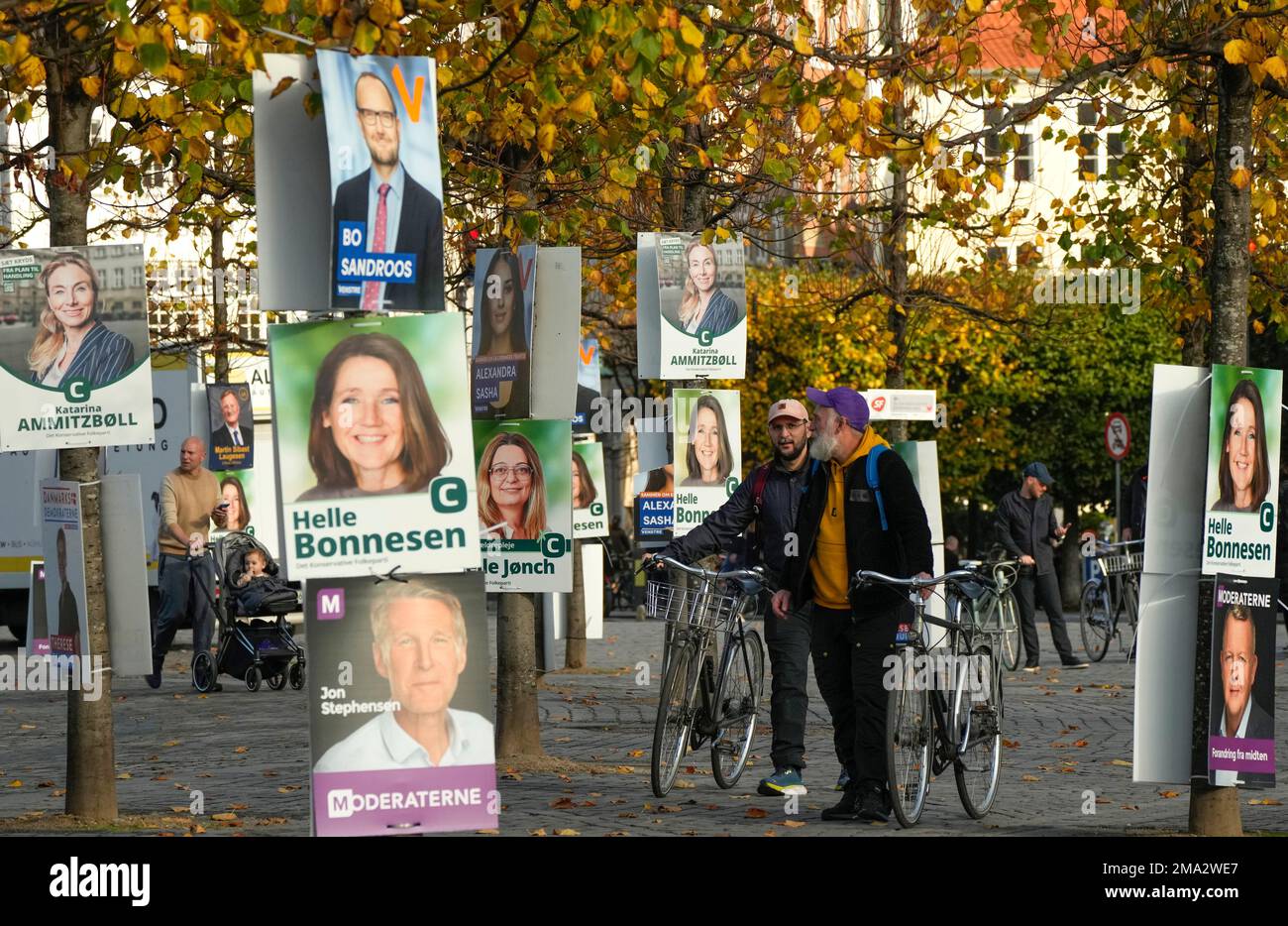 People pass by election campaign posters in Copenhagen, Denmark, Sunday ...