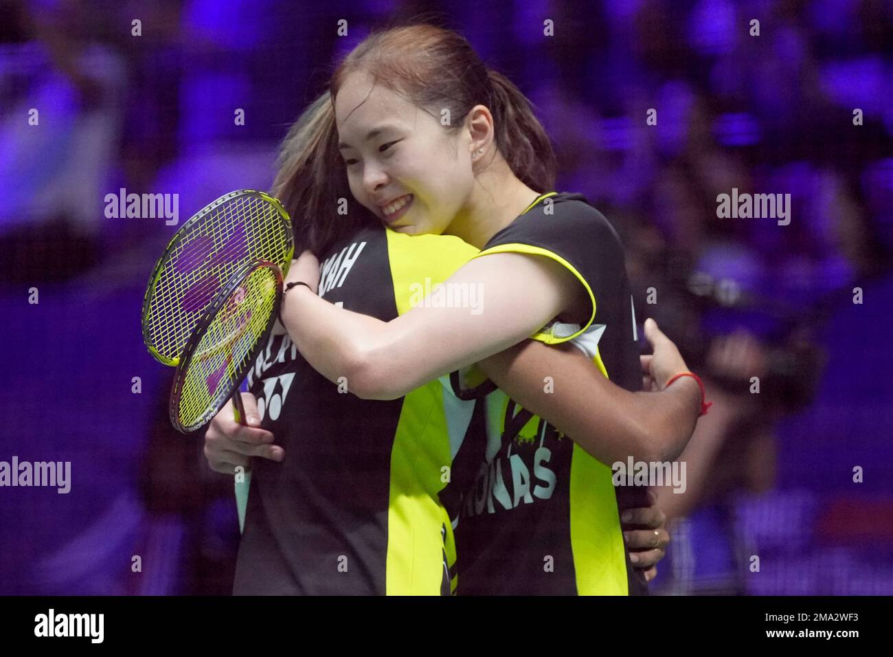 Pearly Tan, right, and Thinaah Muralitharan of Malaysia react after defeating Mayu Matsumoto and ...