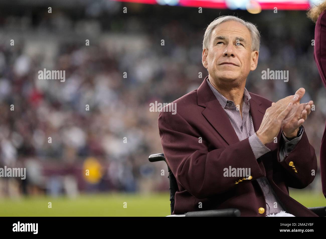 Texas Governor Greg Abbott looks into the crowd at Kyle Field before ...