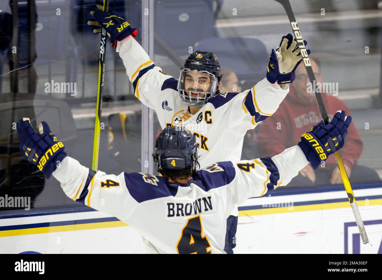Merrimack College forward Ben Brar (18) celebrates with defenseman Mike ...