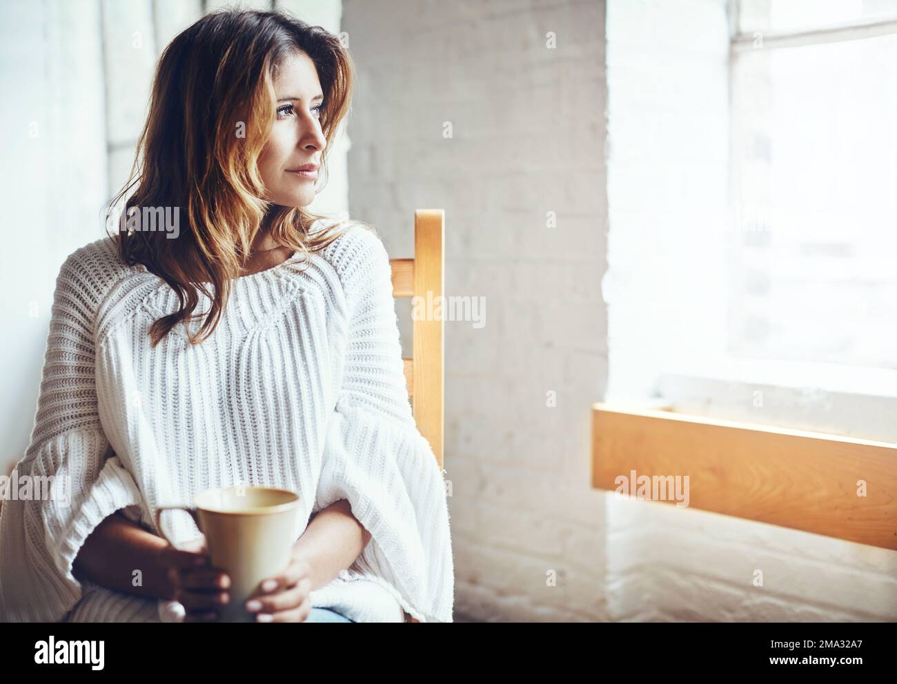 Relax, thinking and woman drinking coffee in her home, content and ...