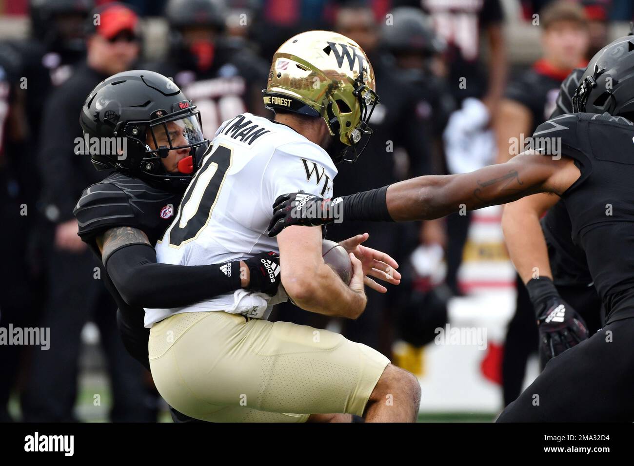 Wake Forest quarterback Sam Hartman is sacked by Louisville defensive ...