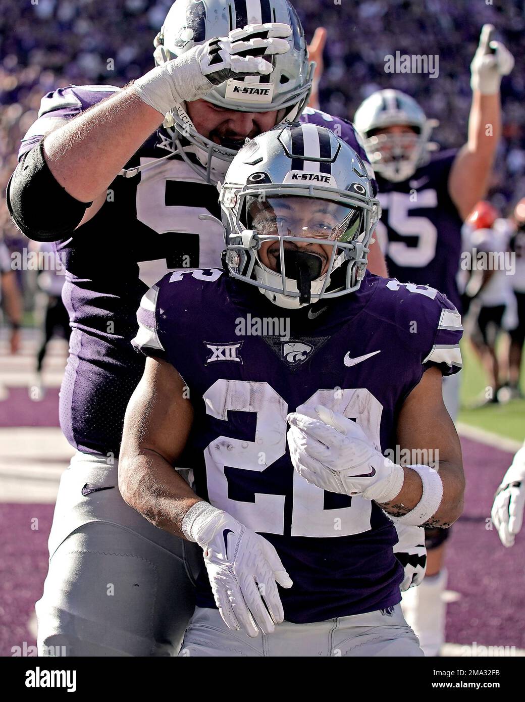 Kansas State running back Deuce Vaughn, center, celebrates with ...