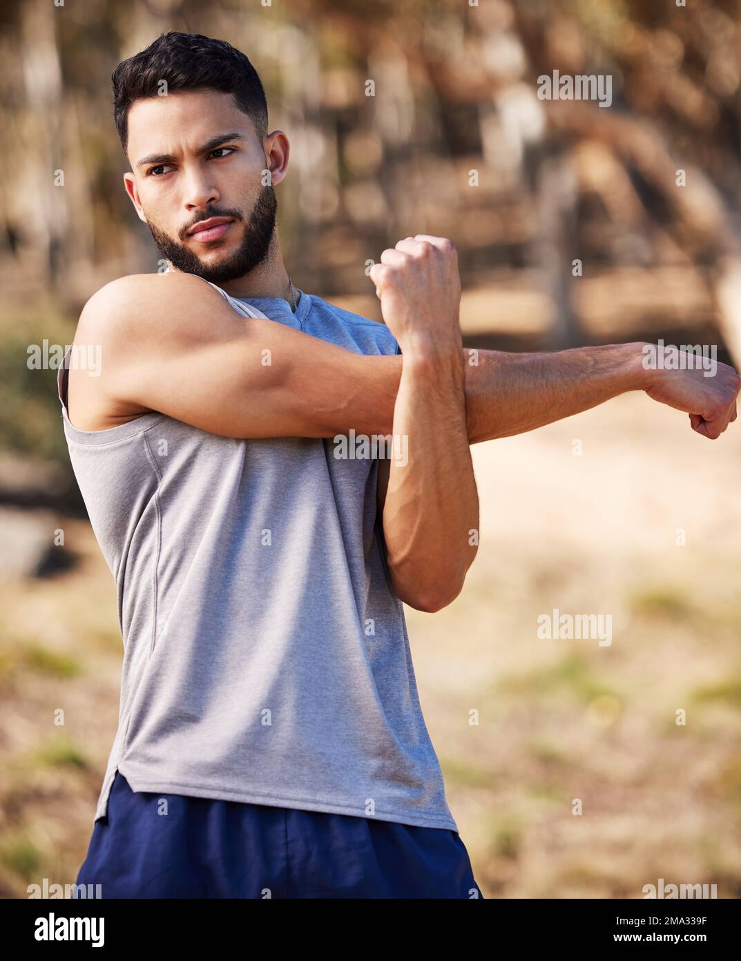 Its time to hustle for muscle. a handsome young man standing alone ...