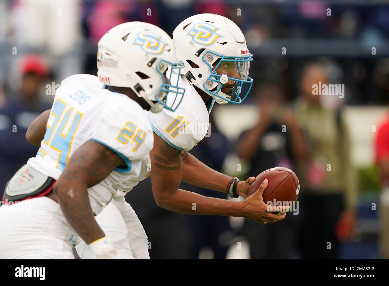 Southern University quarterback Besean McCray (11) hands off to running ...