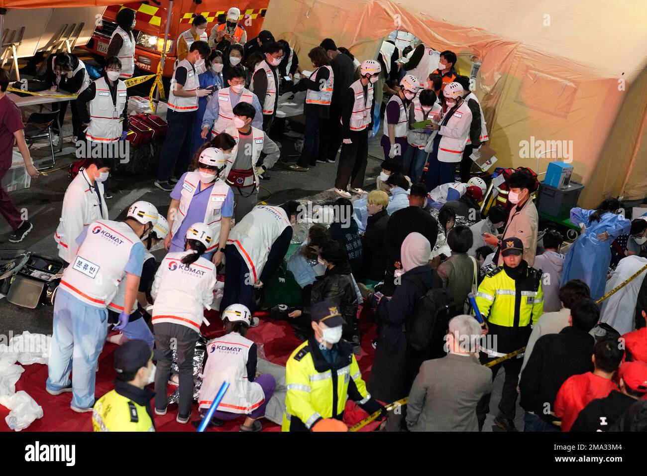 Rescue workers treat injured people on the street near the scene in ...