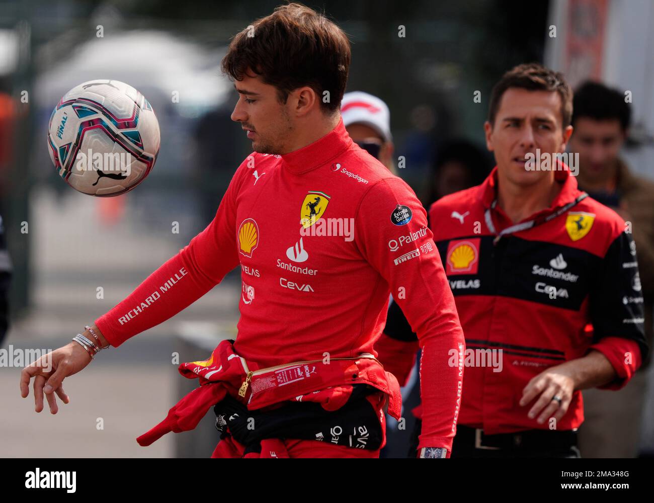 Ferrari driver Charles Leclerc, of Monaco, plays with a soccer ball ...
