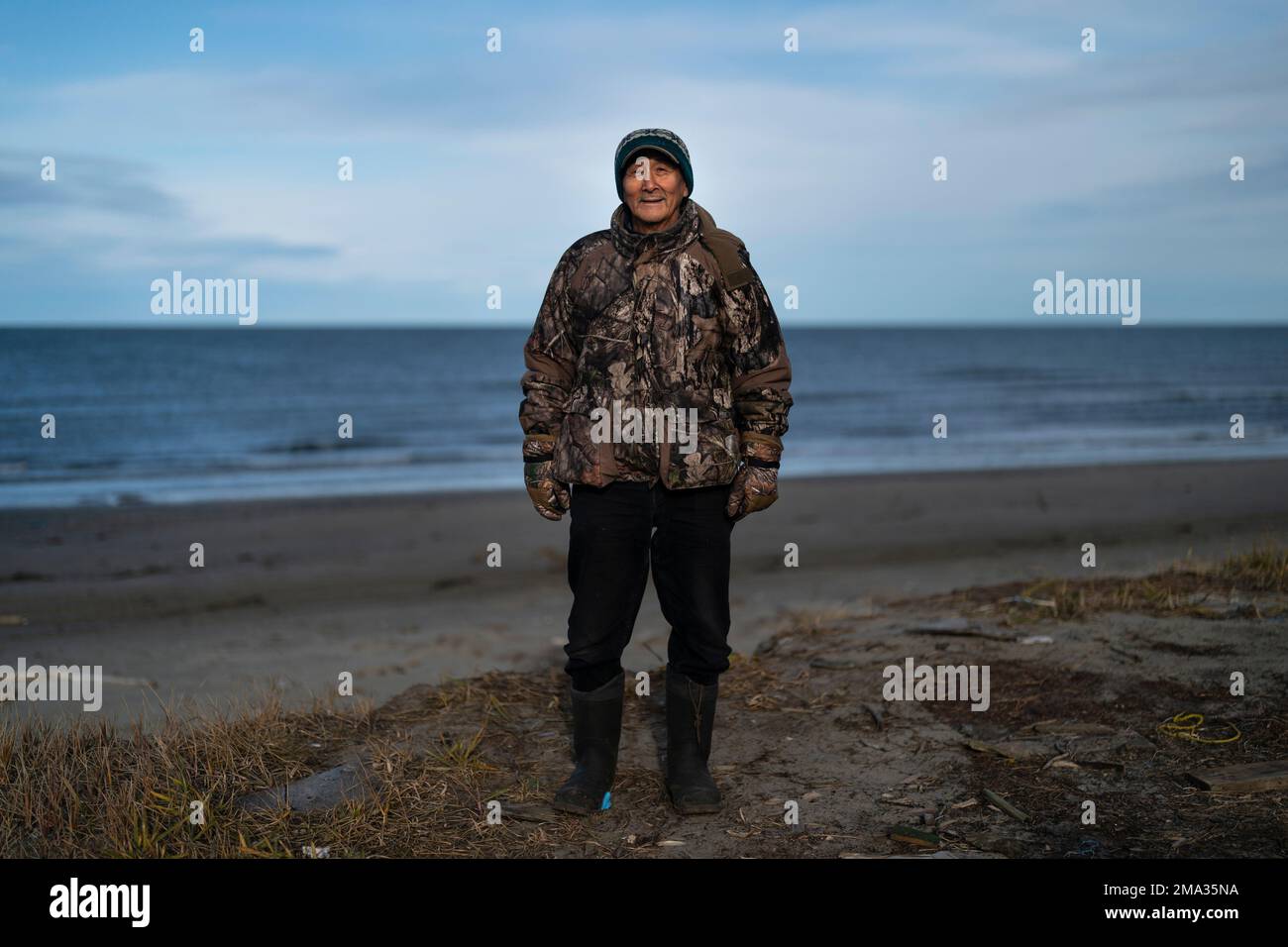 John Sinnok, 73, stands for a photo with the Arctic Ocean behind him in ...