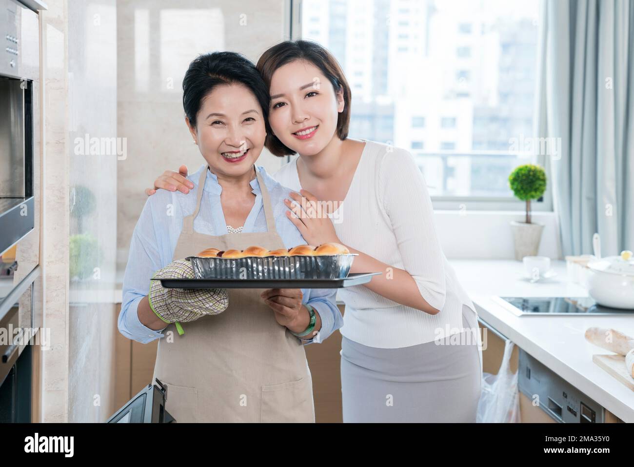 Mother and daughter two people bake bread in the kitchen Stock Photo ...