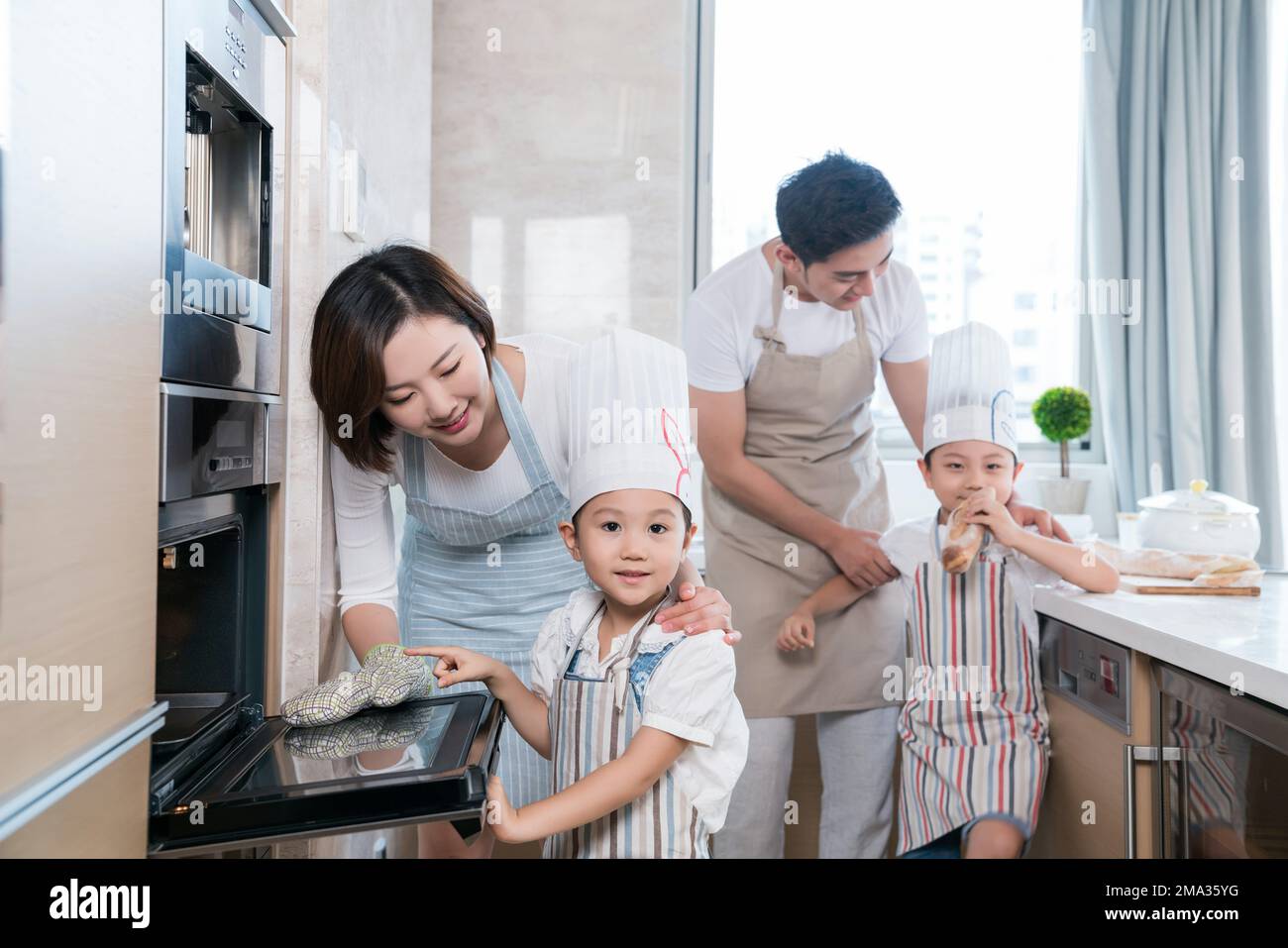 Siblings do household chores in kitchen hi-res stock photography and ...