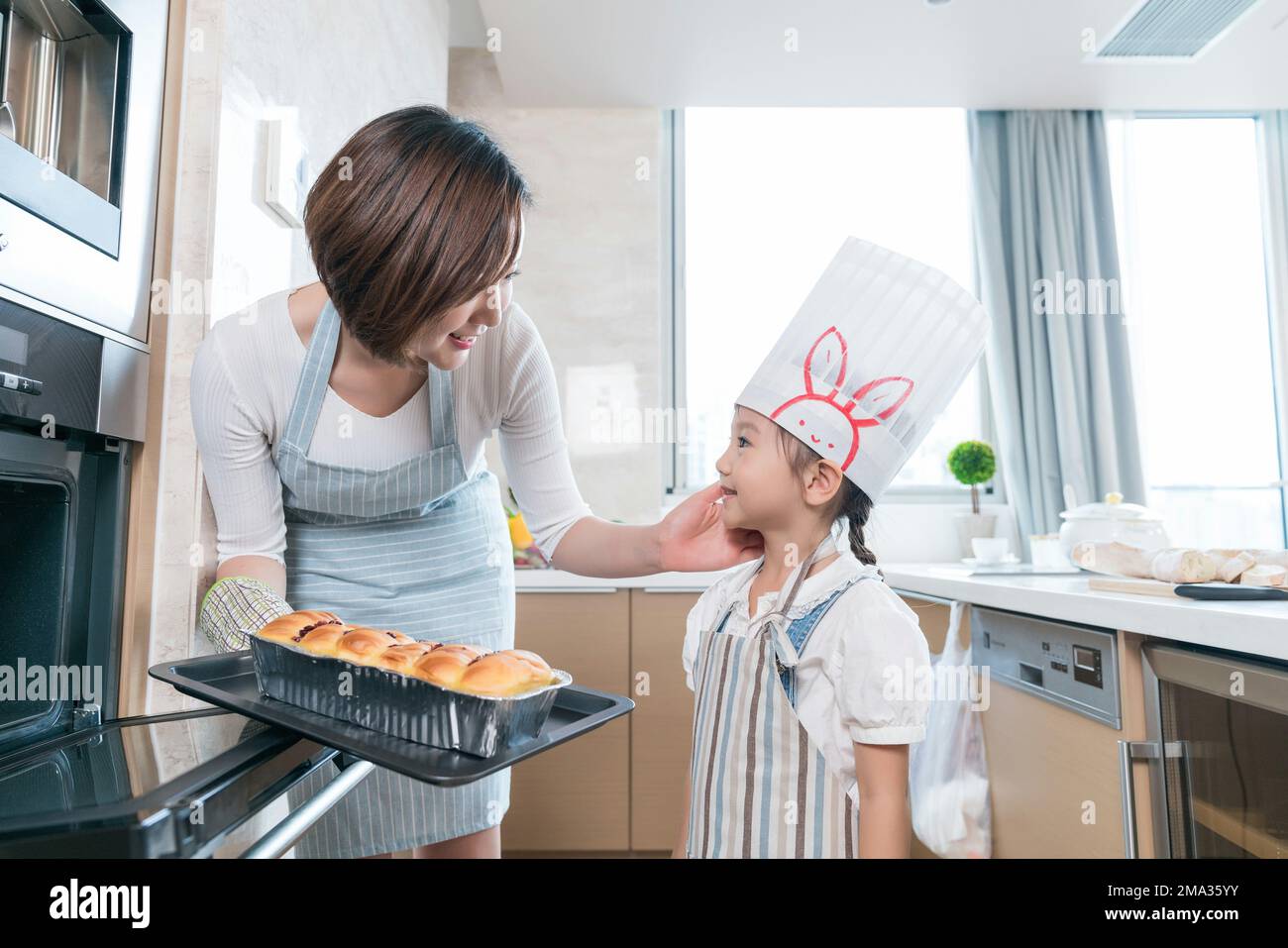 Mother and daughter two people bake bread in the kitchen Stock Photo ...