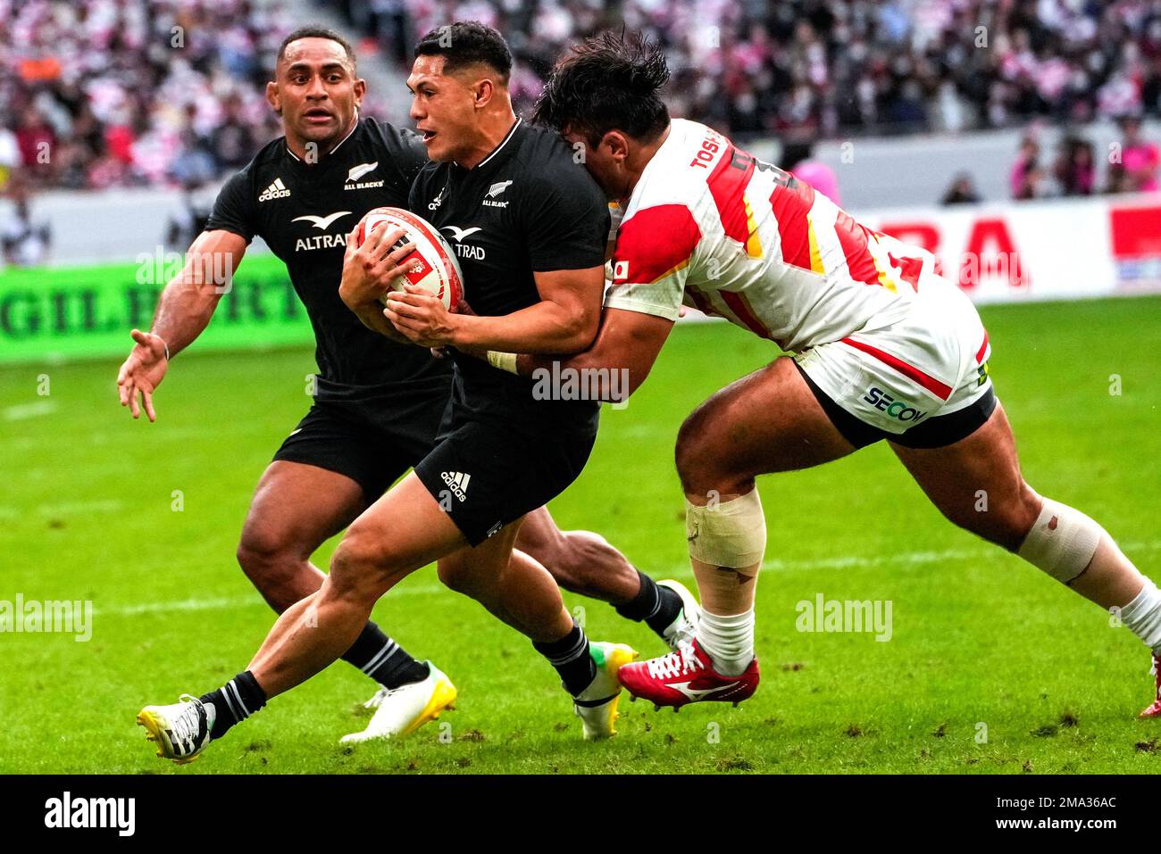 New Zealand's Roger Tuivasa-Sheck is tackled by Japan's Gu Jiwon, right ...