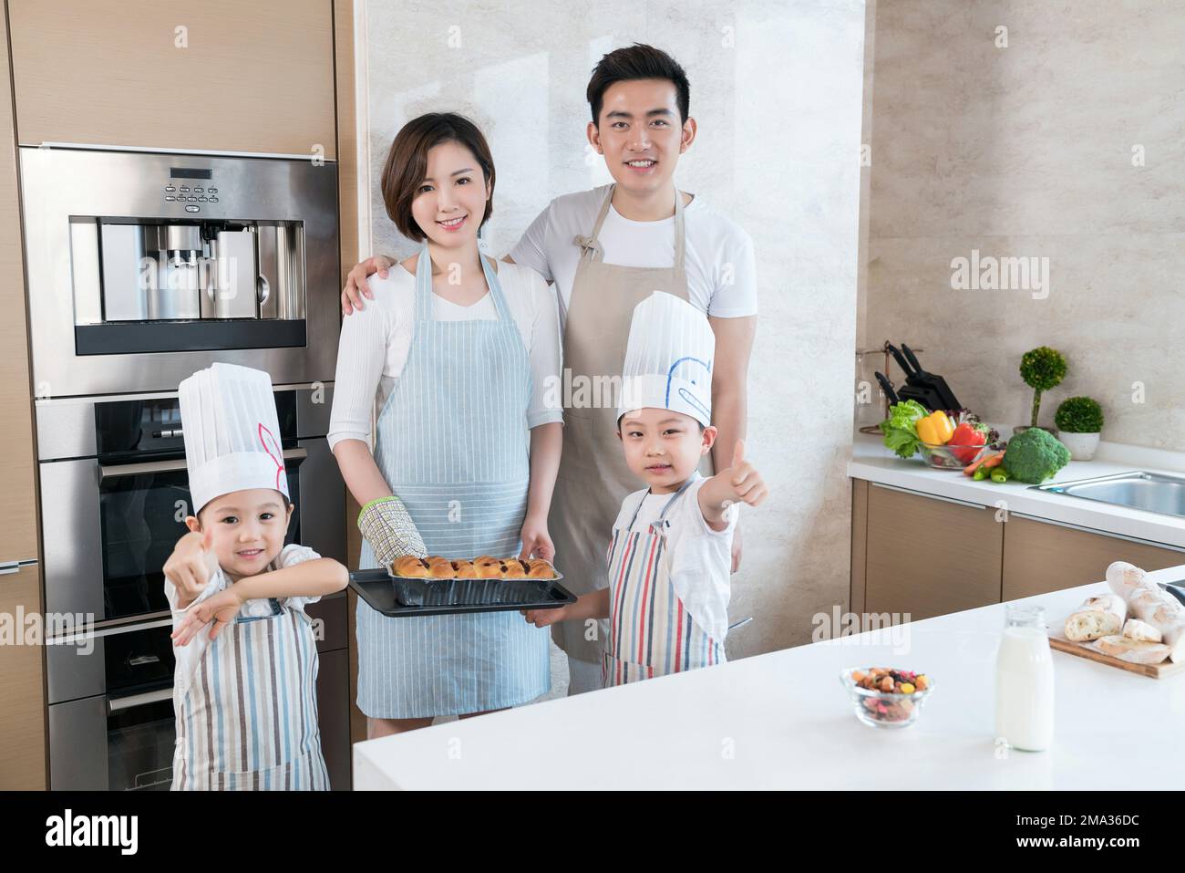 Siblings do household chores in kitchen hi-res stock photography and ...