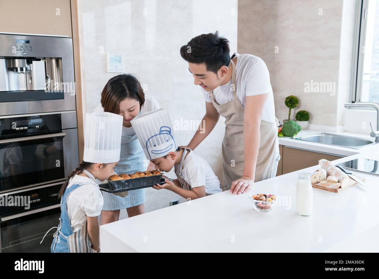 Siblings do household chores in kitchen hi-res stock photography and ...