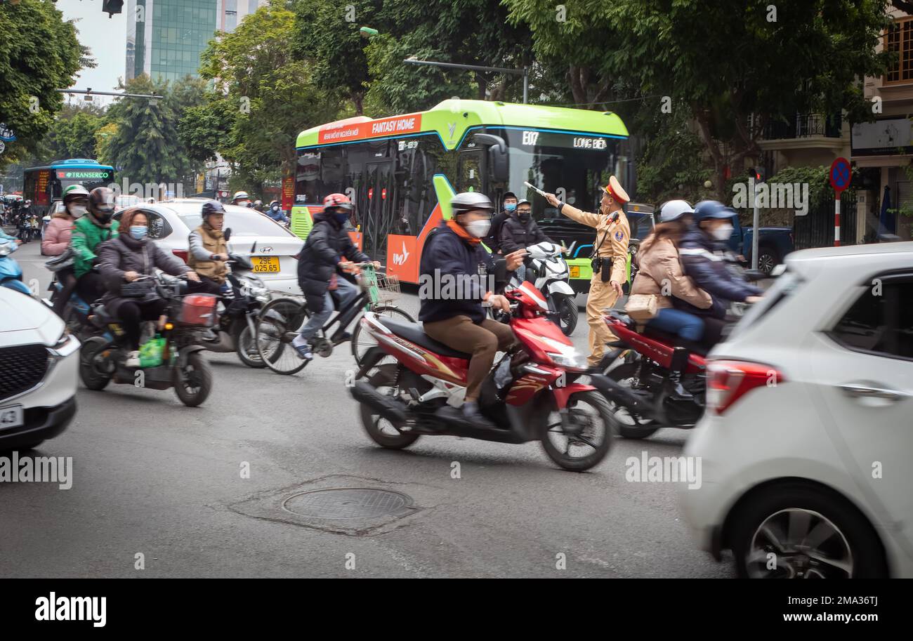 A traffic policeman waves his baton as he tries to bring order to a ...