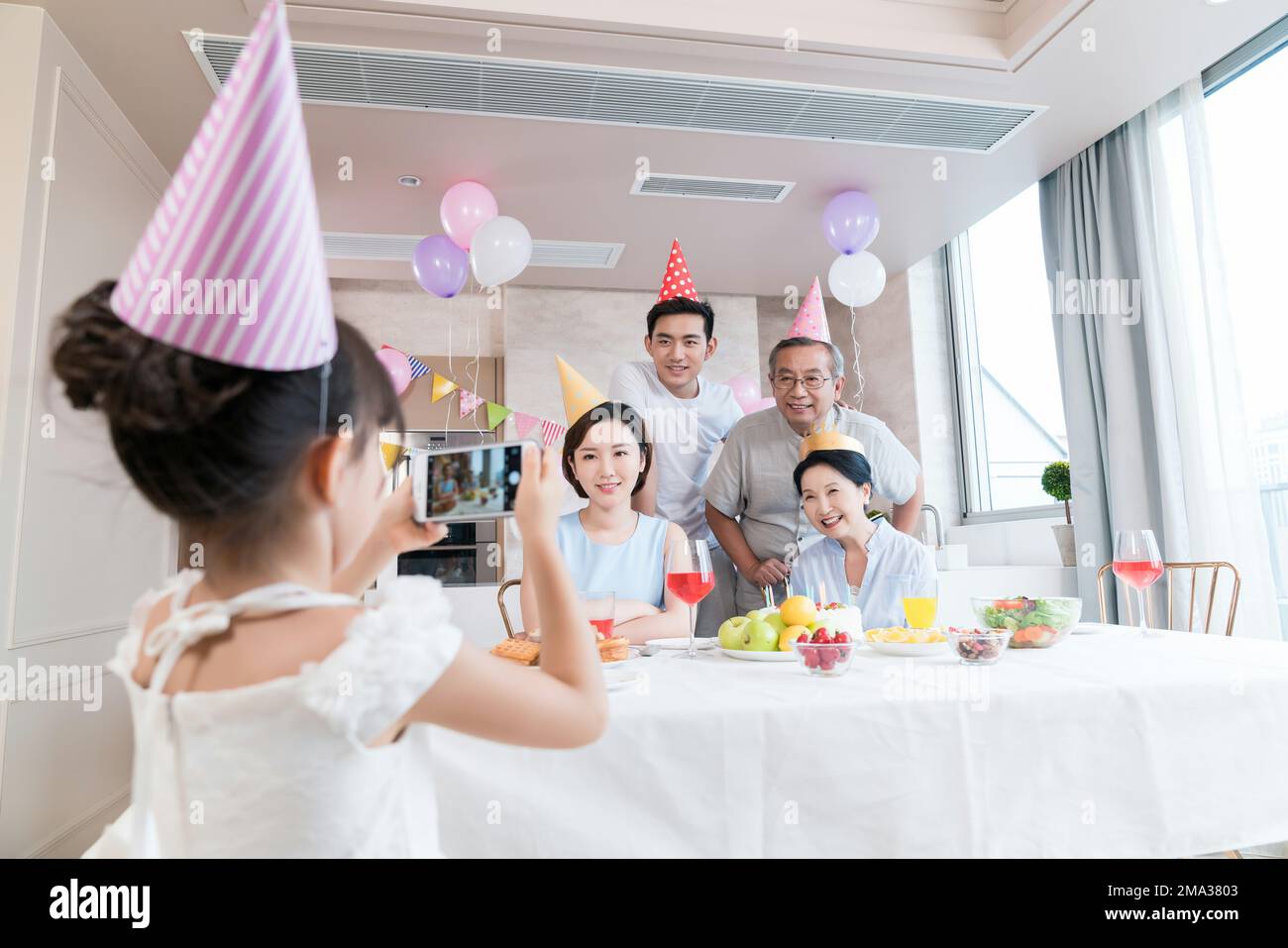 Happy family party to celebrate in the kitchen Stock Photo - Alamy