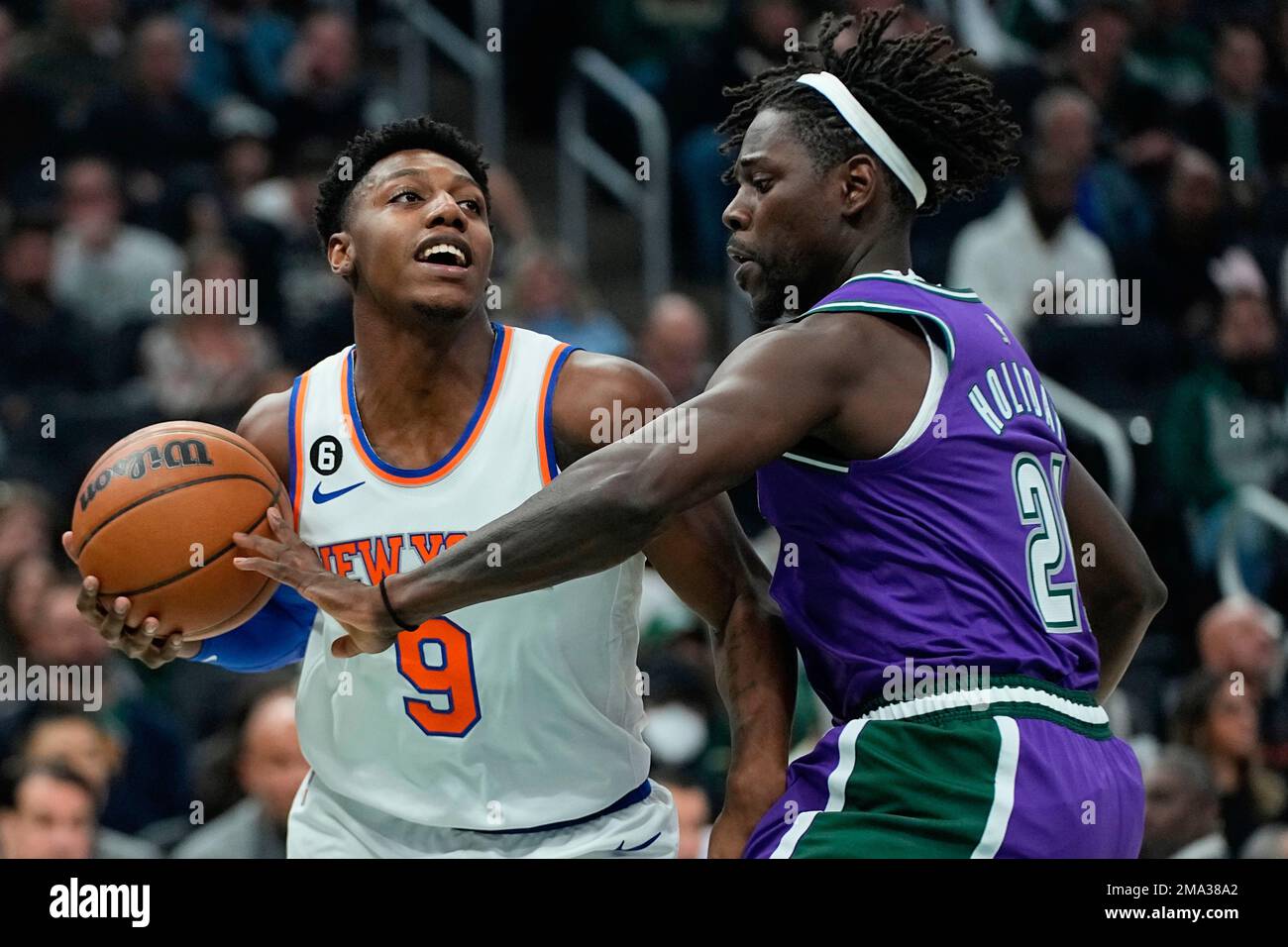 Milwaukee Bucks' Jrue Holiday fouls New York Knicks' RJ Barrett during ...