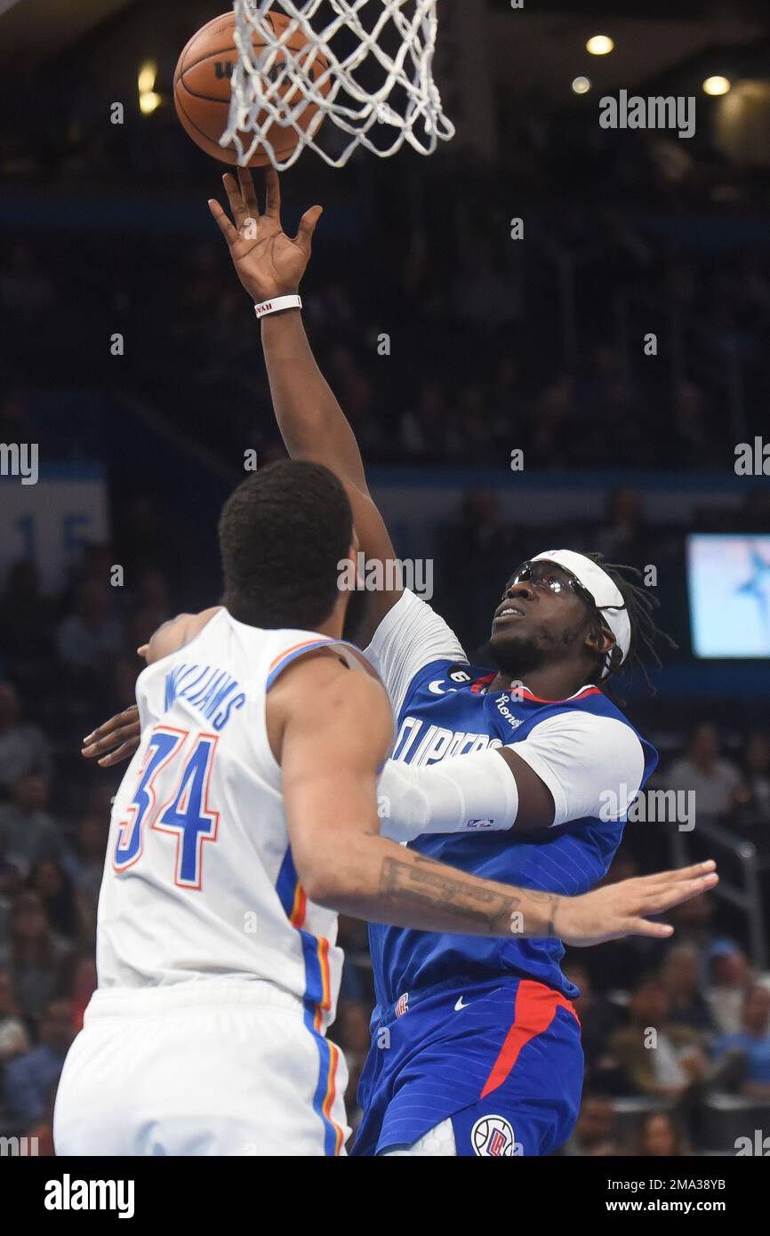 Los Angeles Clippers guard Reggie Jackson, right, goes up for a shot ...