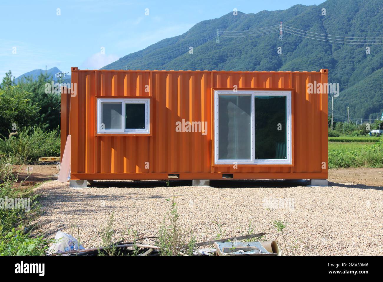Orange shipping container office in rural construction site Stock Photo ...