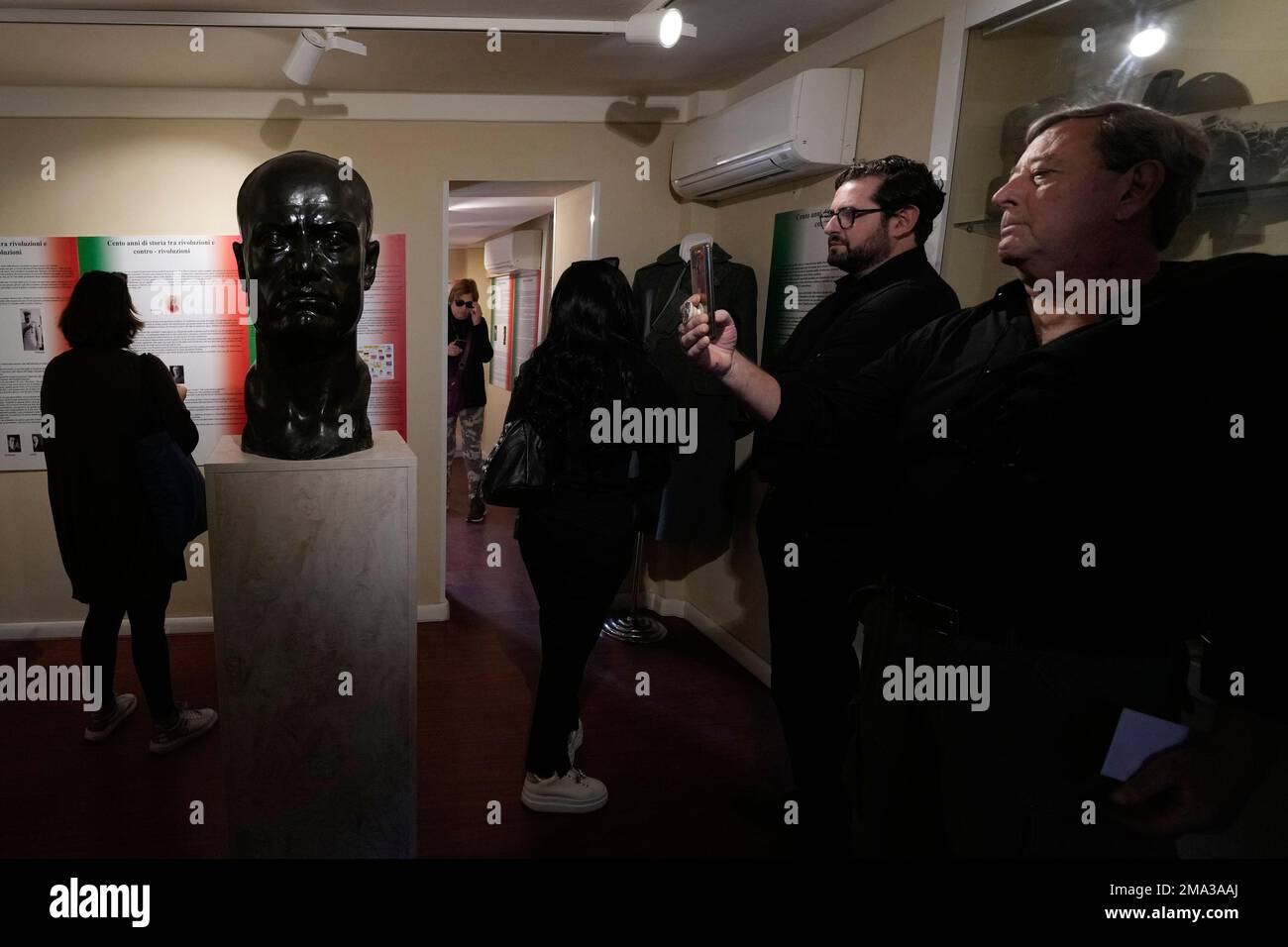 People man takes pictures of Benito Mussolini bust during the ...