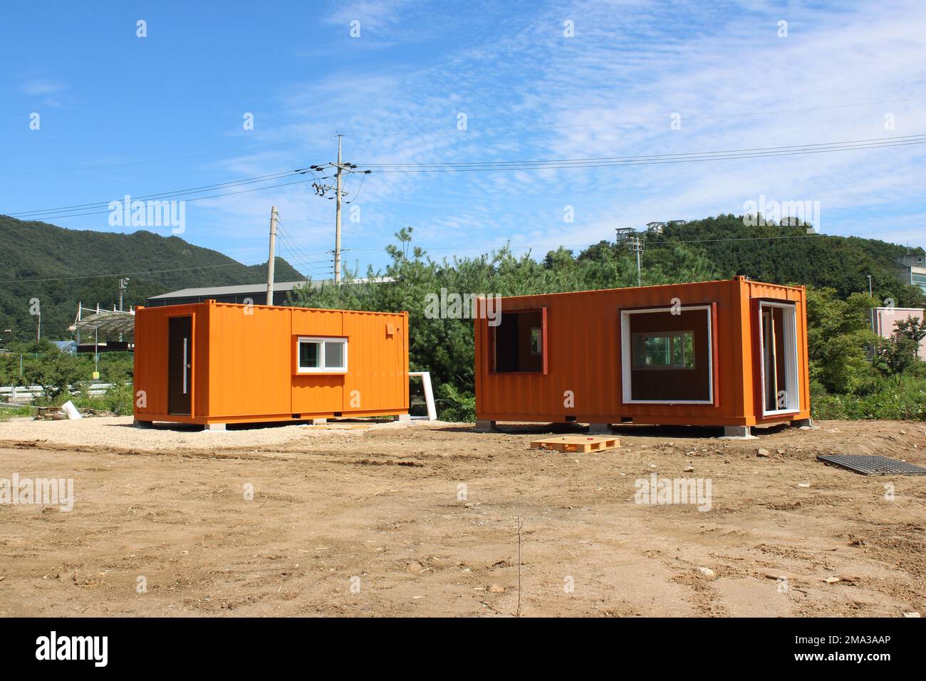 Orange shipping container office in rural construction site Stock Photo ...