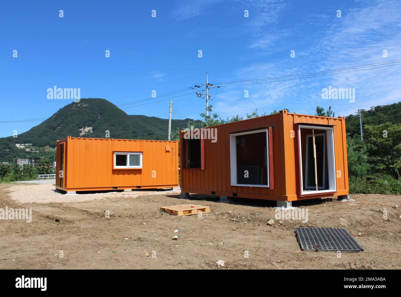 Orange shipping container office in rural construction site Stock Photo ...