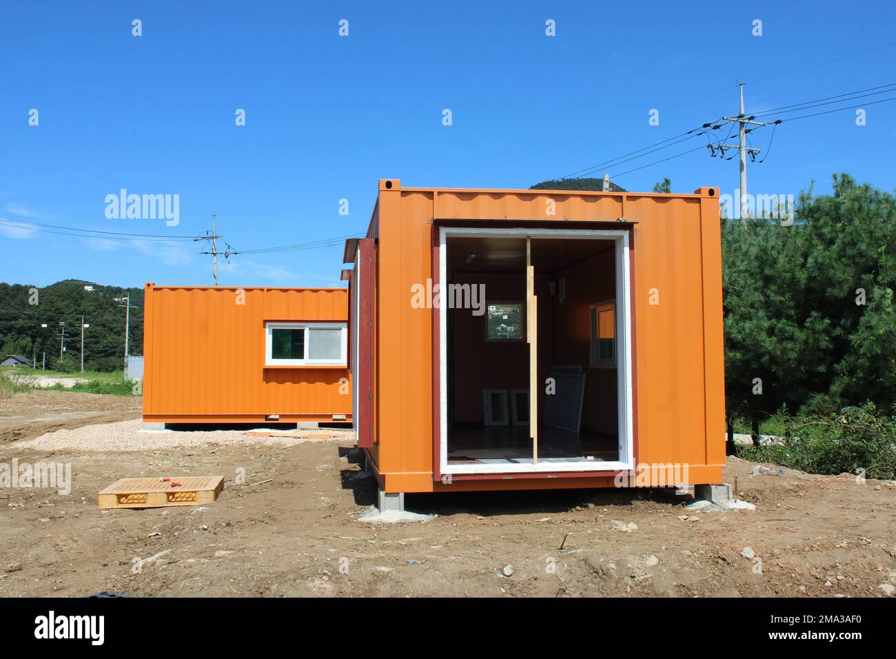 Orange shipping container office in rural construction site Stock Photo ...