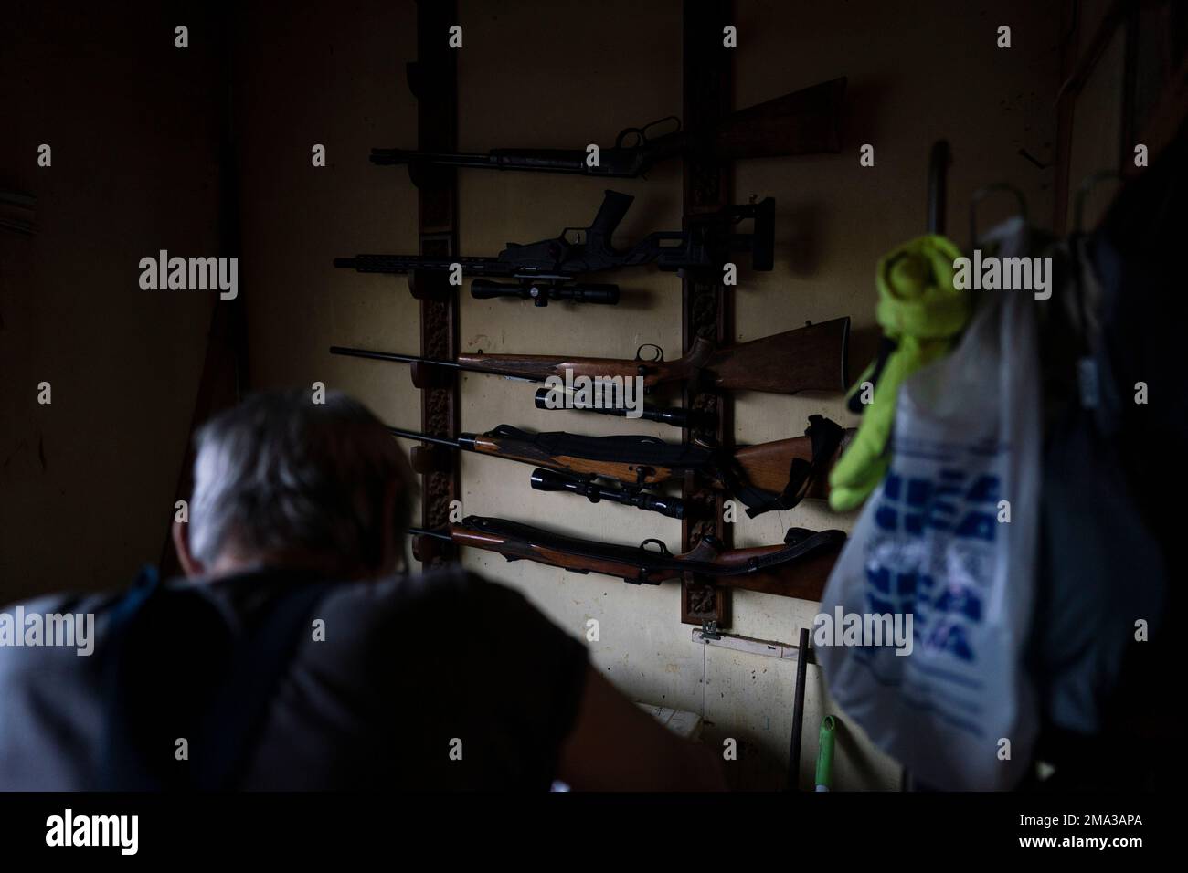 Hunting rifles hang on a rack as 80-year-old Clifford Weyiouanna ...