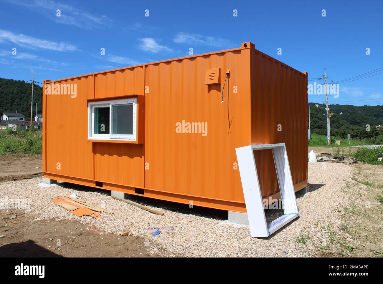 Orange shipping container office in rural construction site Stock Photo ...