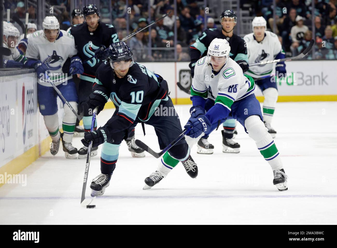 Seattle Kraken center Matty Beniers (10) skates with the puck ahead of ...