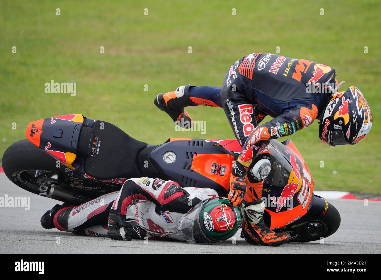 Spain's Pedro Acosta of Red Bull KTM Ajo, top, crashes with Thailand's ...