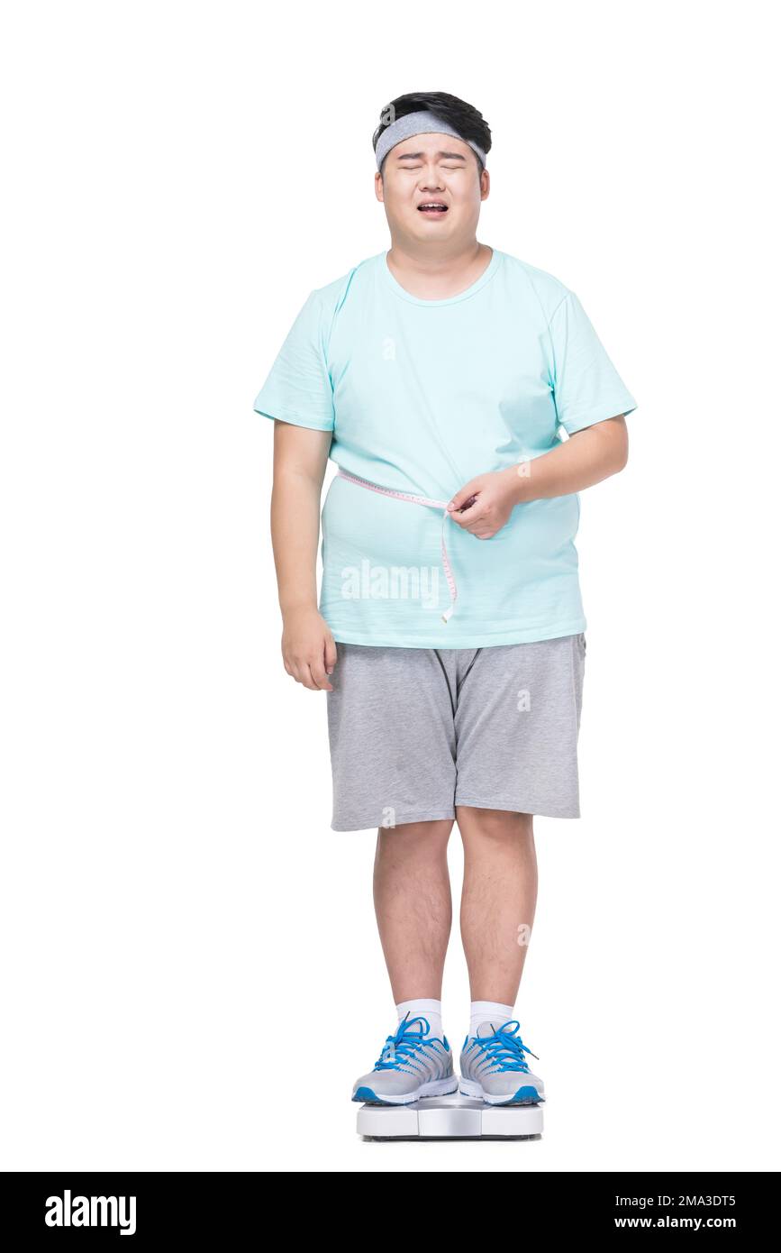 Obese young man weight and waist circumference measurement Stock Photo ...
