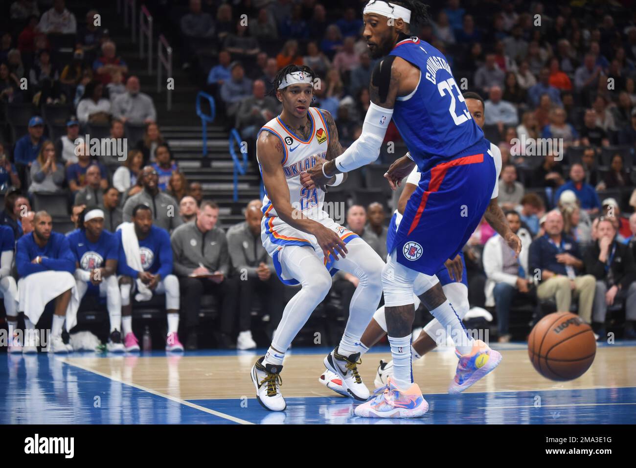Oklahoma City Thunder guard Tre Mann, left, passes the ball around Los ...