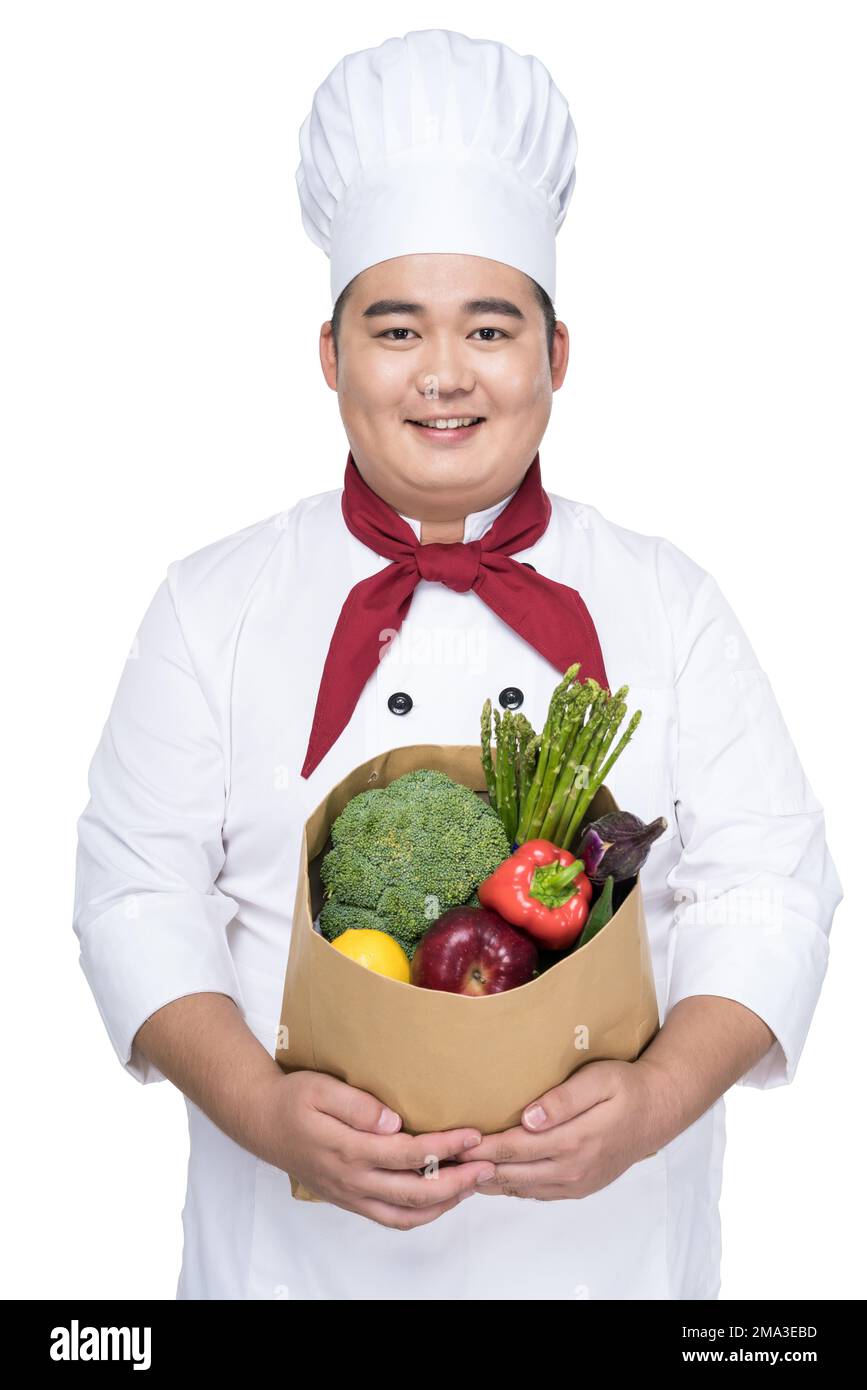 Obese chef holding a bag of vegetables Stock Photo - Alamy