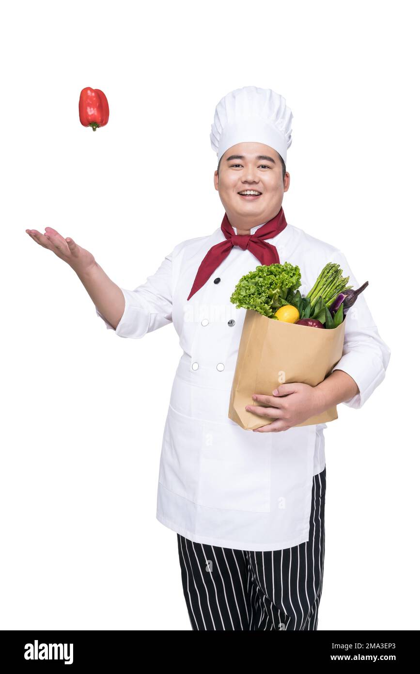 Obese chef holding a bag of vegetables Stock Photo - Alamy