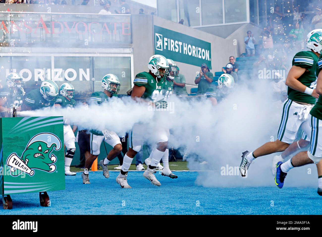 Tulane runs on the field before an NCAA college football game against ...
