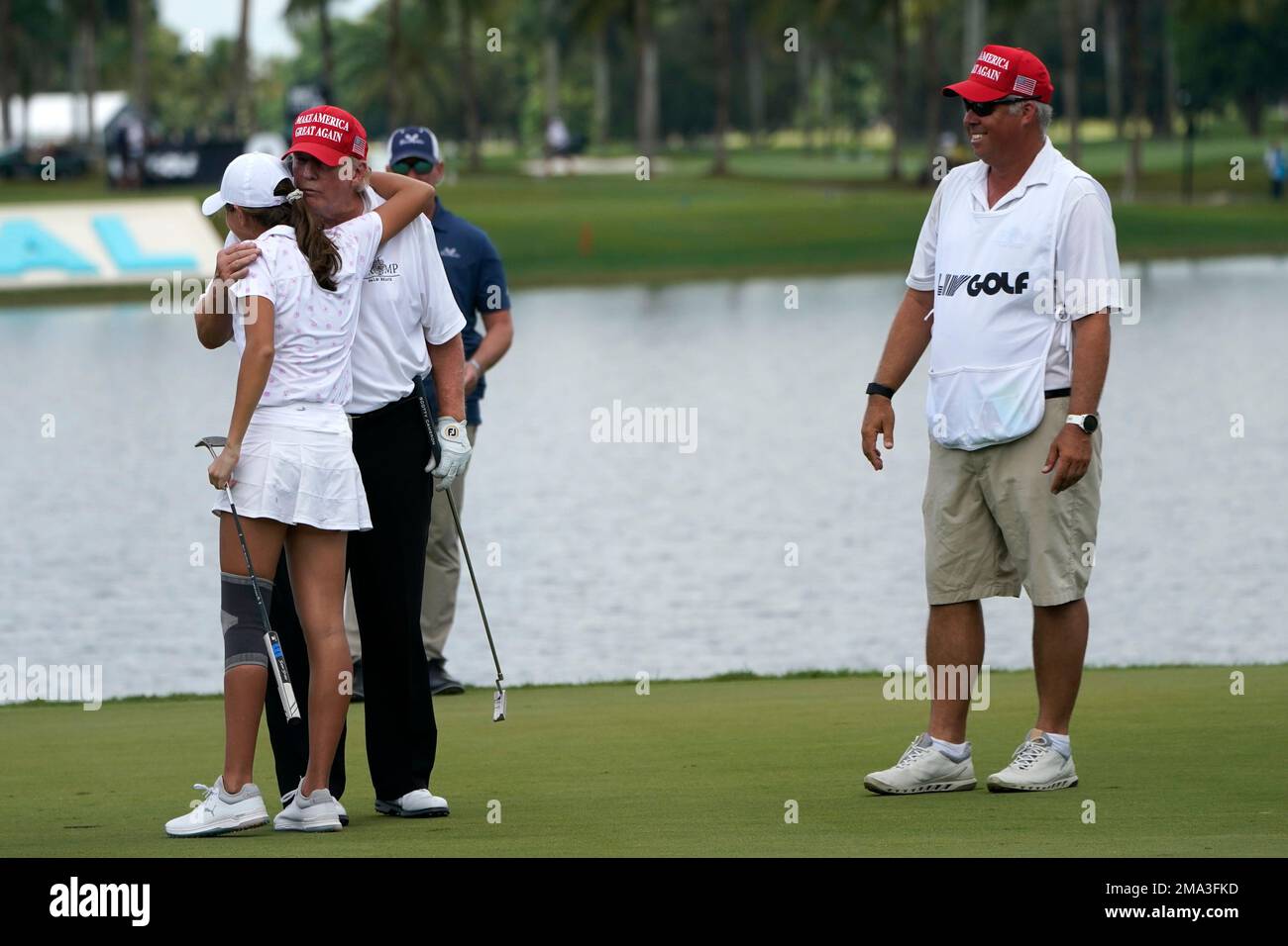 Former President Donald Trump, left hugs his granddaughter Kai Trump as ...