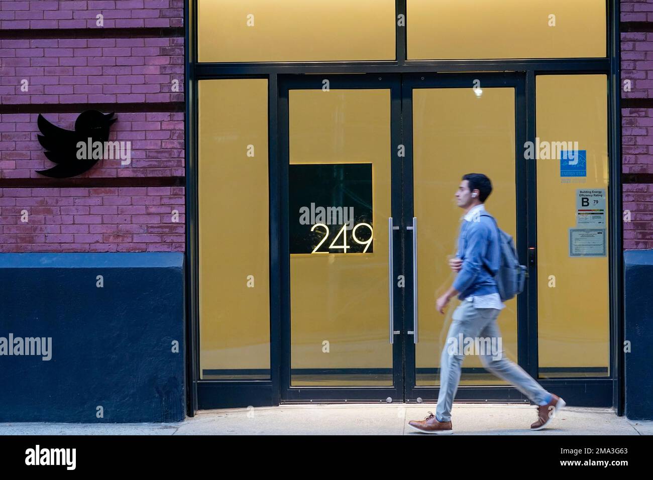 A pedestrian walks past the building that houses the Twitter office in ...