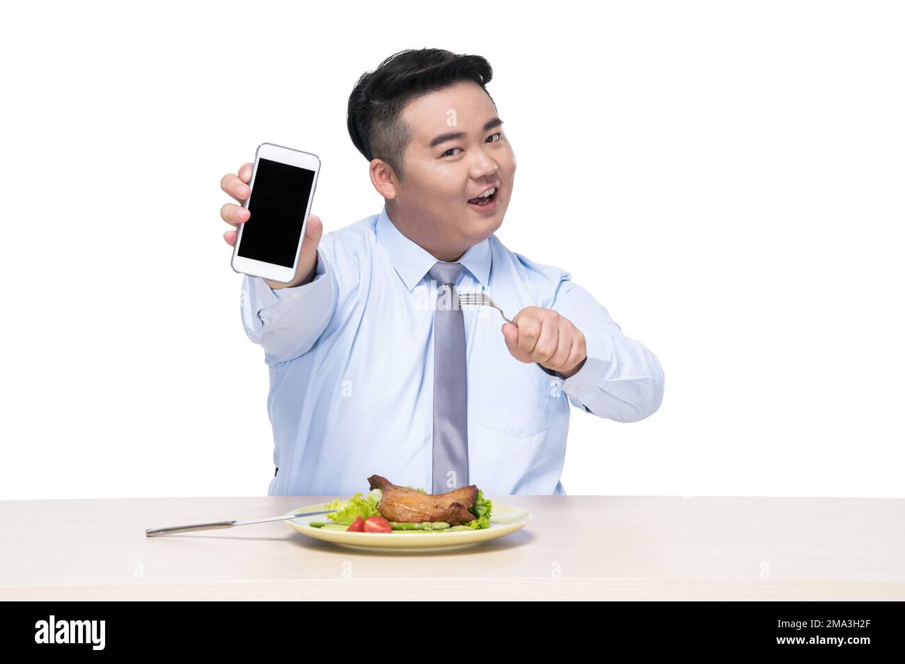 Fat people eat in with mobile phone Stock Photo - Alamy