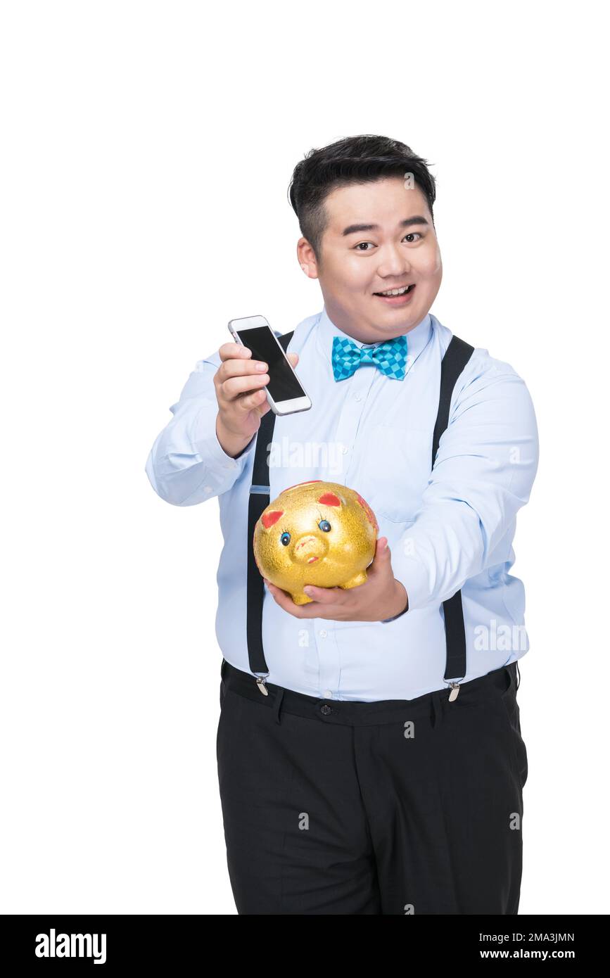 With a piggy bank and mobile phone fat young men Stock Photo - Alamy