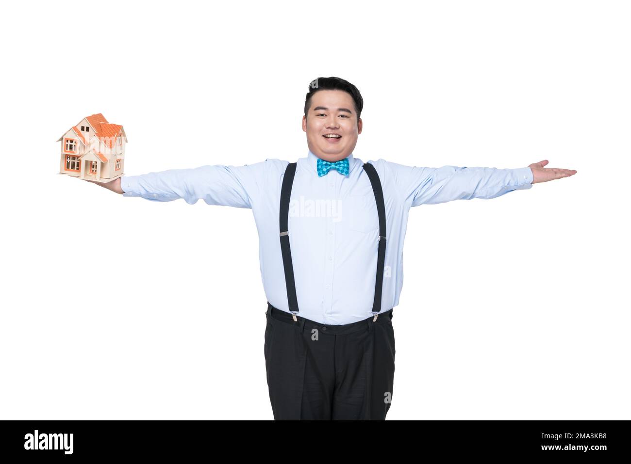 Obese young man with a house model Stock Photo - Alamy