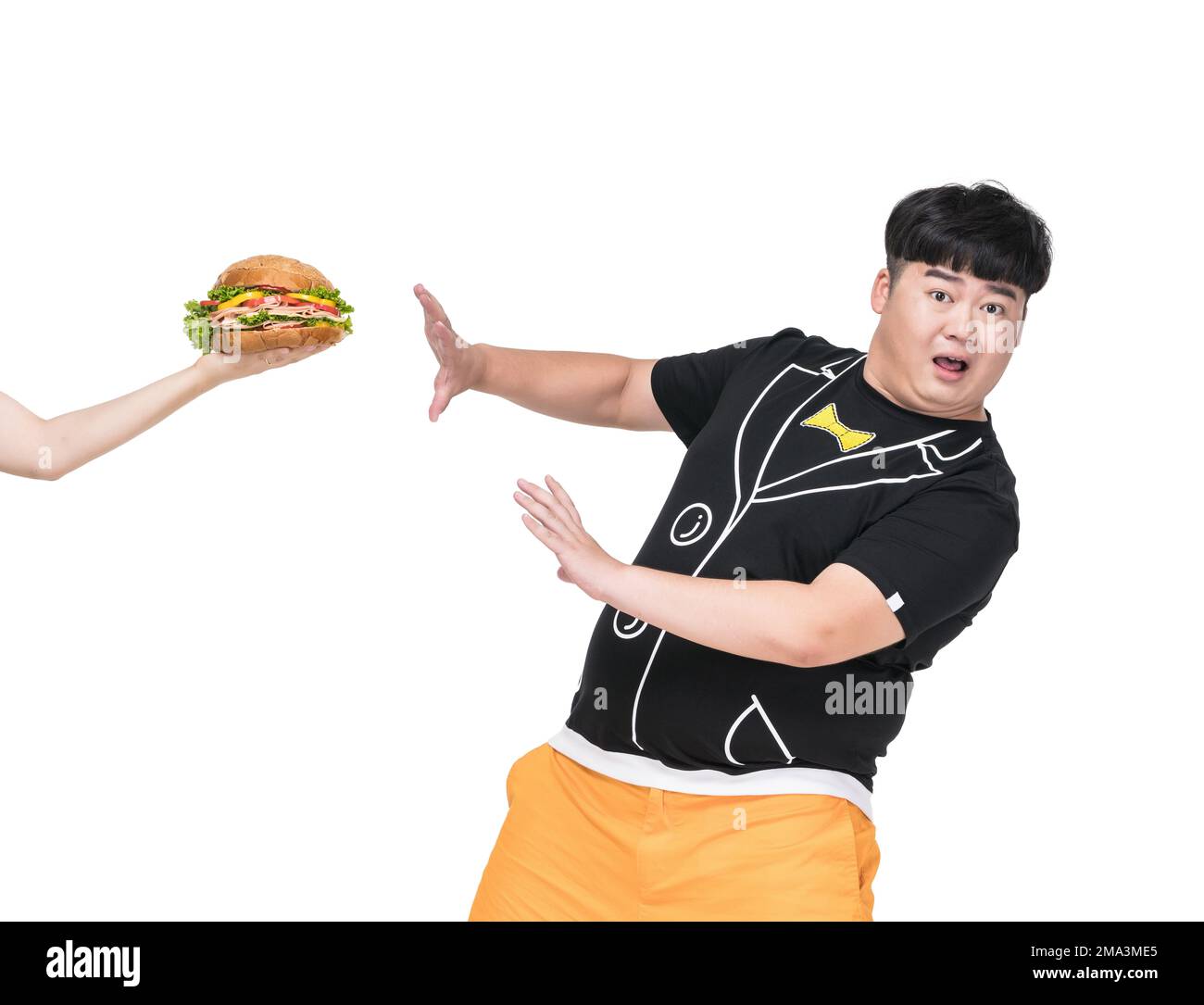 Fat young men to refuse food temptation Stock Photo - Alamy