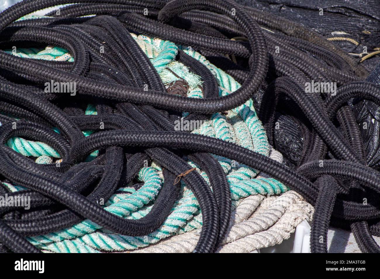 Fishing ropes of various colors and sizes on the ground of the small ...