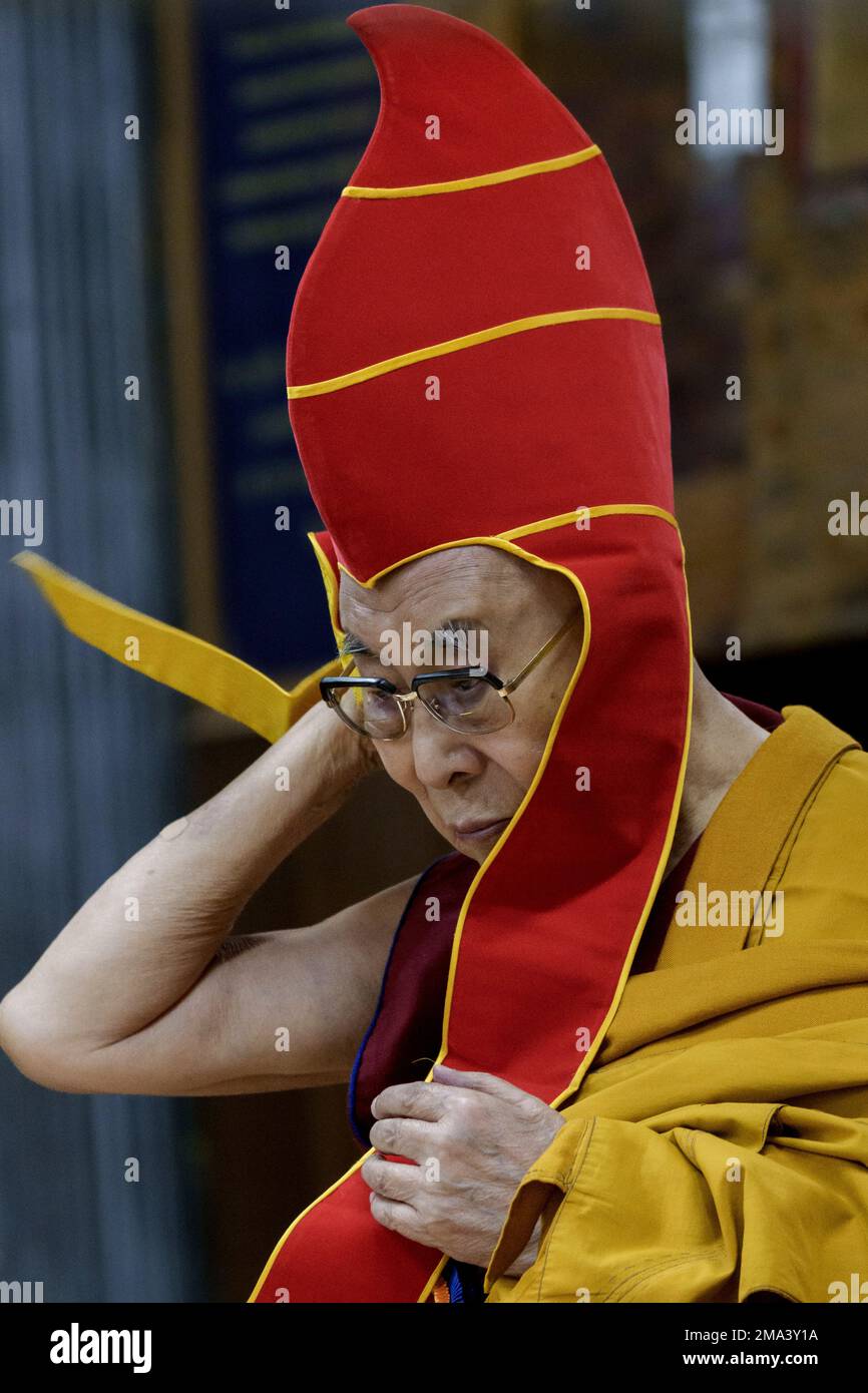 Tibetan spiritual leader the Dalai Lama wears a ceremonial hat as he ...