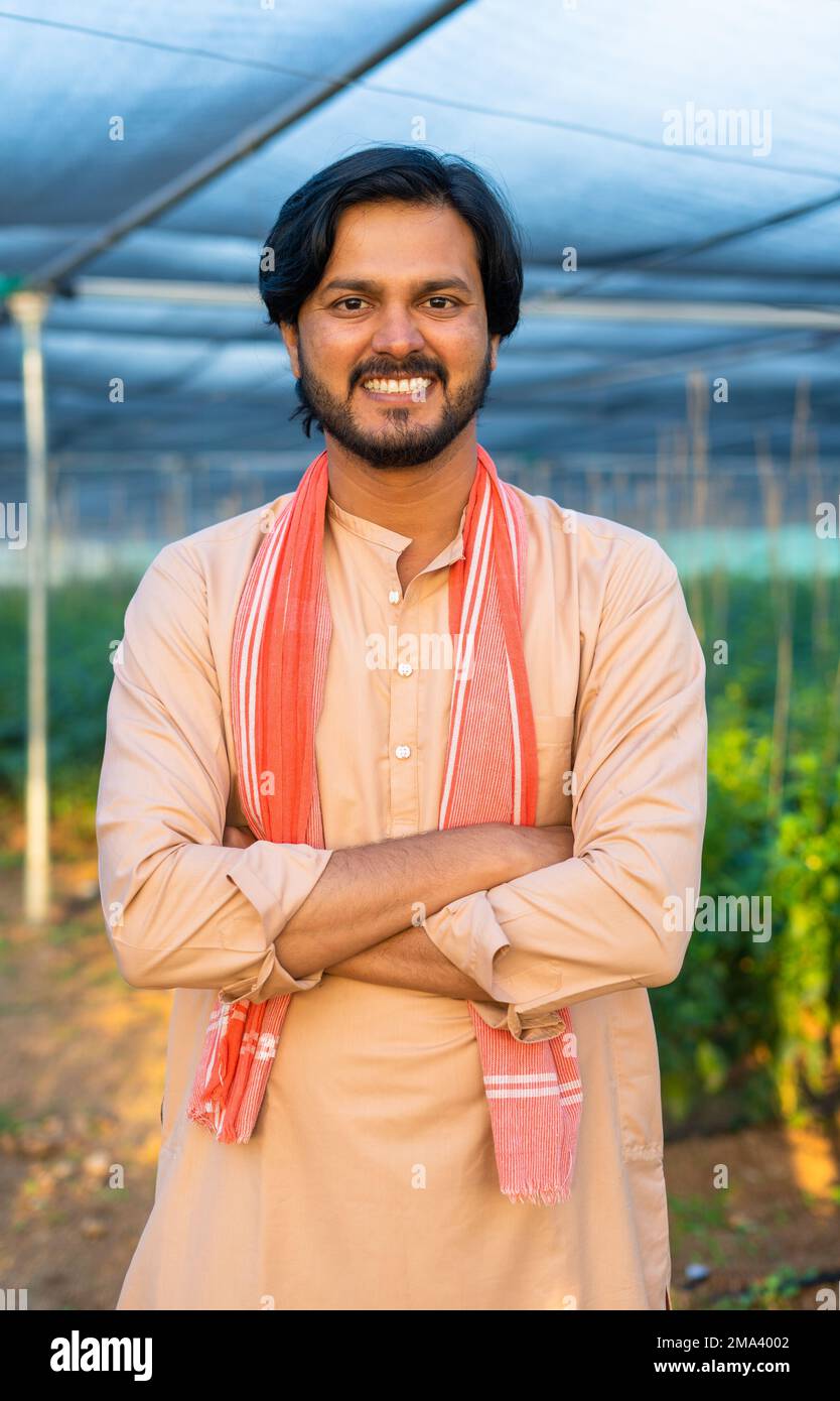 vertical portrait shot of happy young farmer confidently smiling by ...