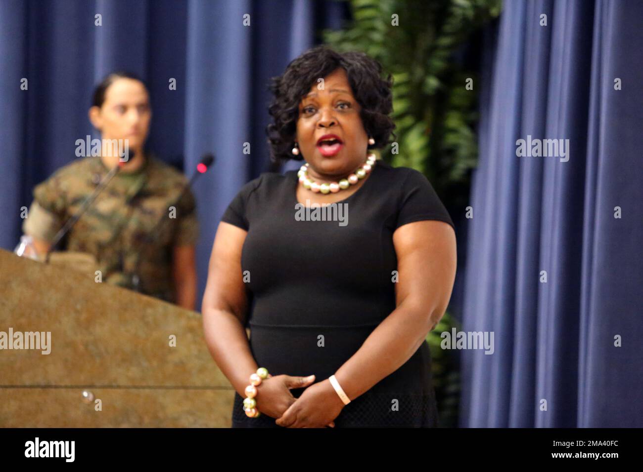 Sandra Inman, a vocalist from Marine Corps Logistics Command sings the ...